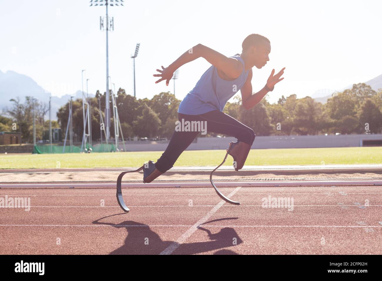 Male athlete with prosthetic legs running on race track Stock Photo - Alamy