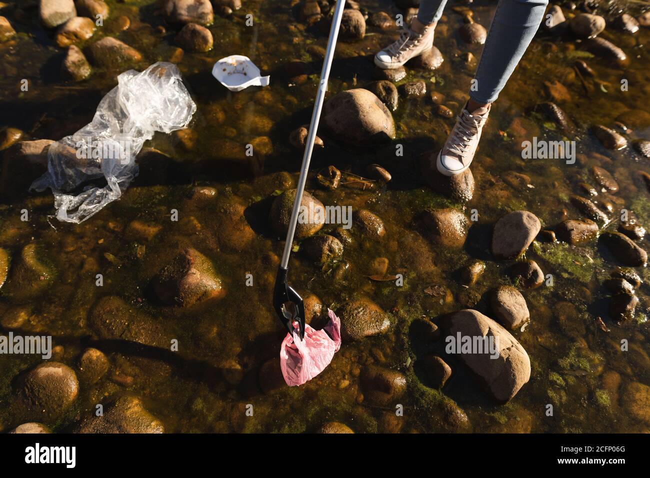 Volunteer cleaning up river in the countryside Stock Photo - Alamy
