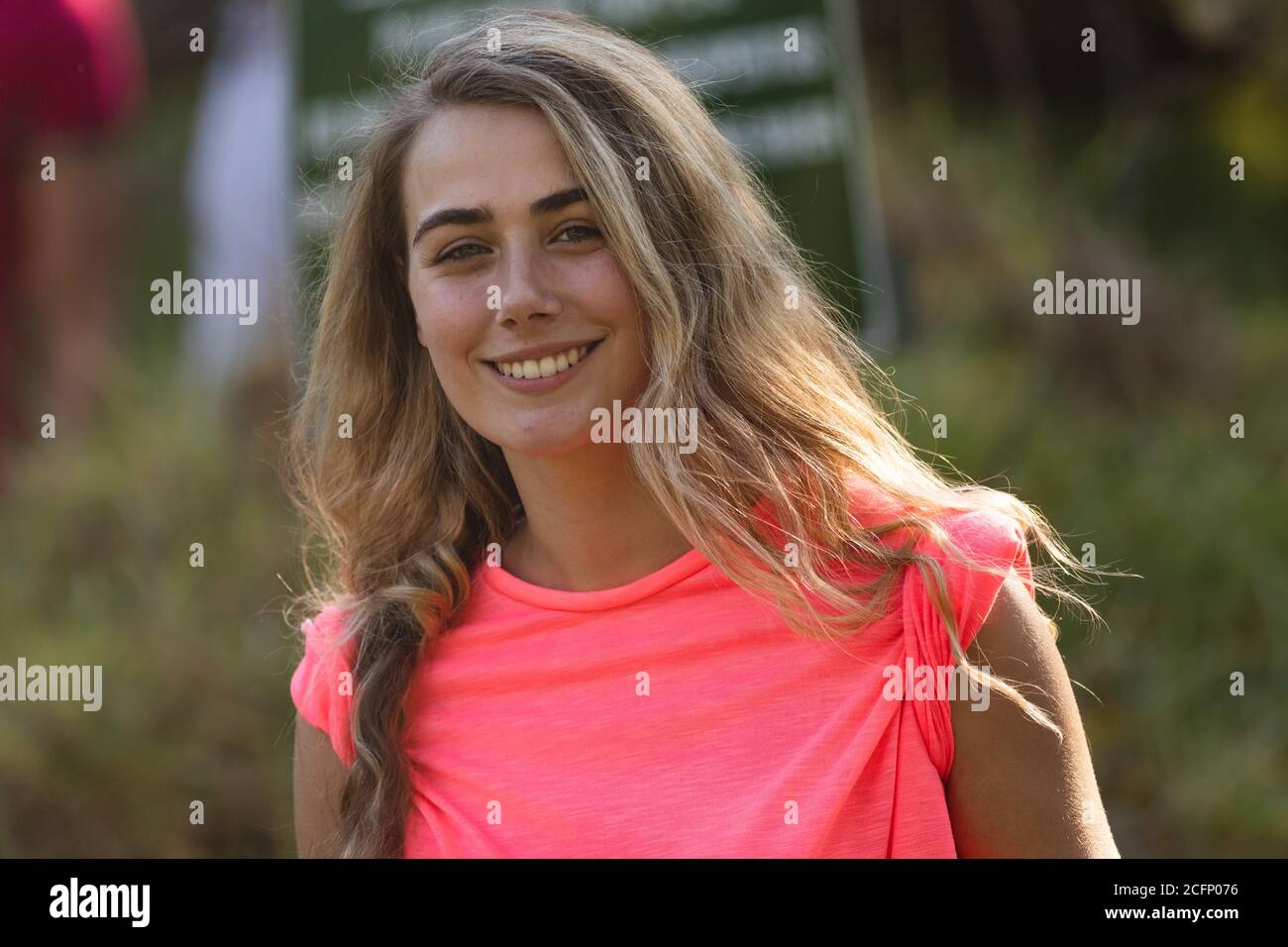 Volunteer smiling to camera Stock Photo - Alamy