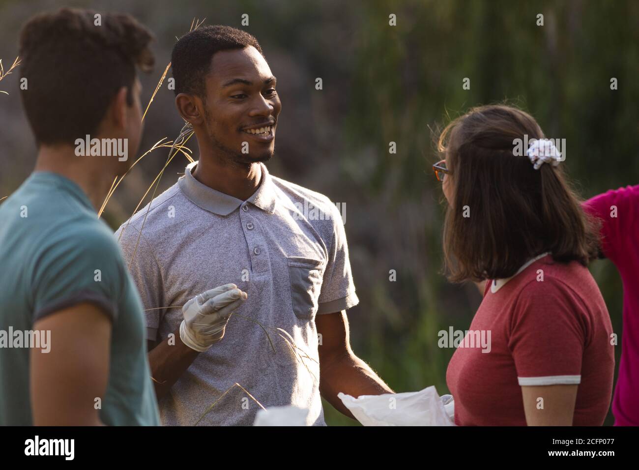 Volunteer smiling to camera Stock Photo - Alamy