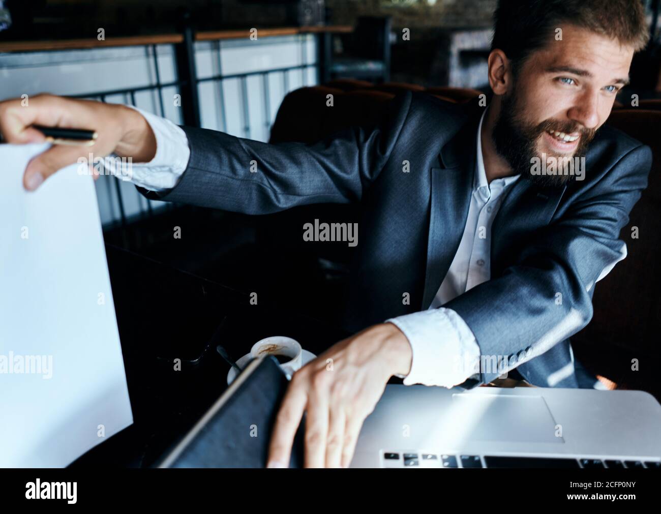 Business man in a cafe suit in front of laptop emotions official ...