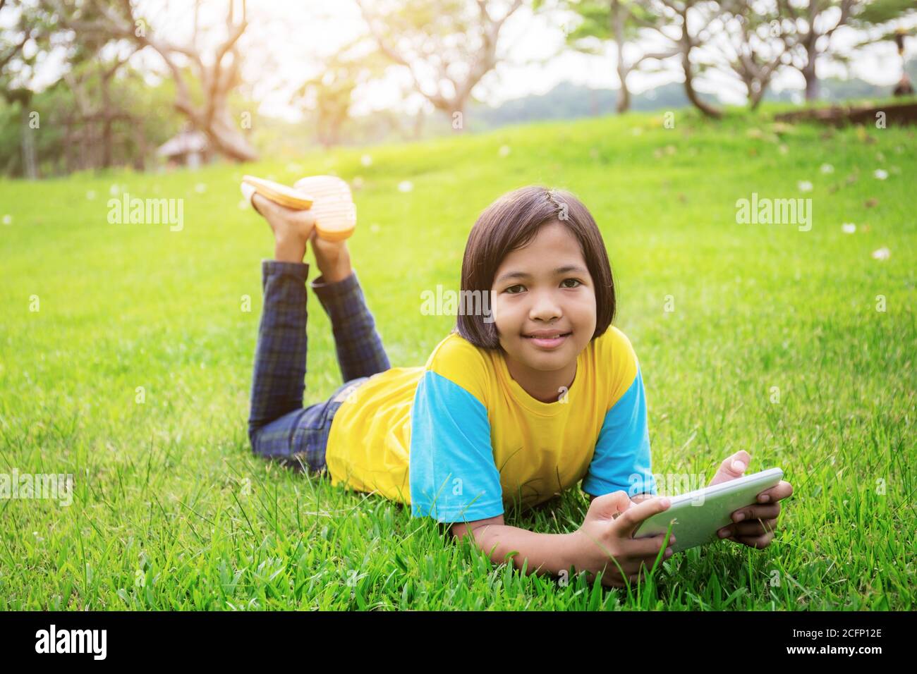 Asian girls are happy on lawn in the park Stock Photo - Alamy