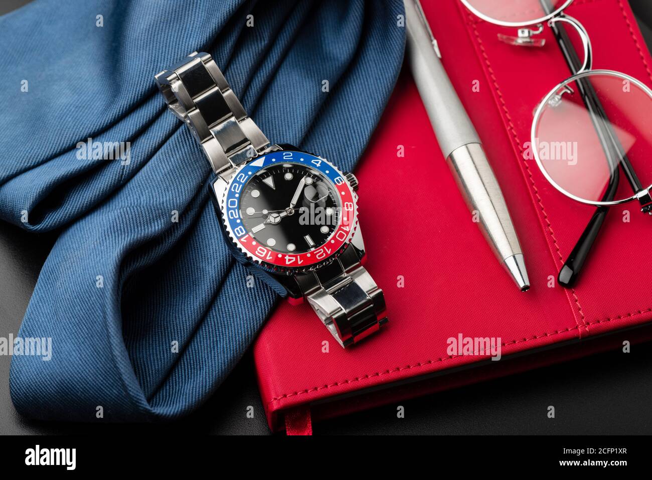 closeup luxury wristwatch for men with black dial blue-red bezel and ...