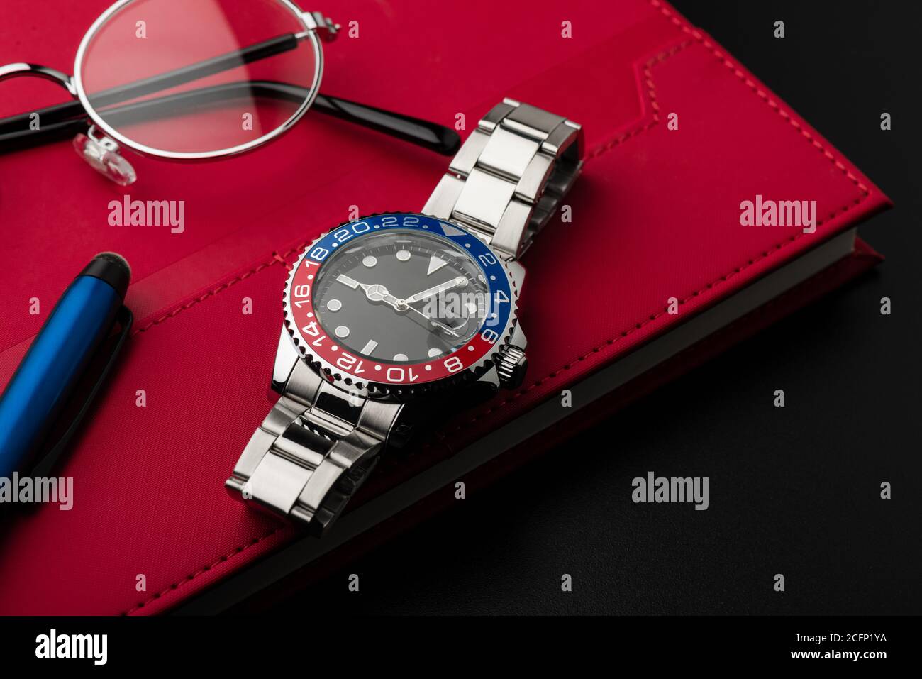 closeup luxury wristwatch for men with black dial blue-red bezel and ...