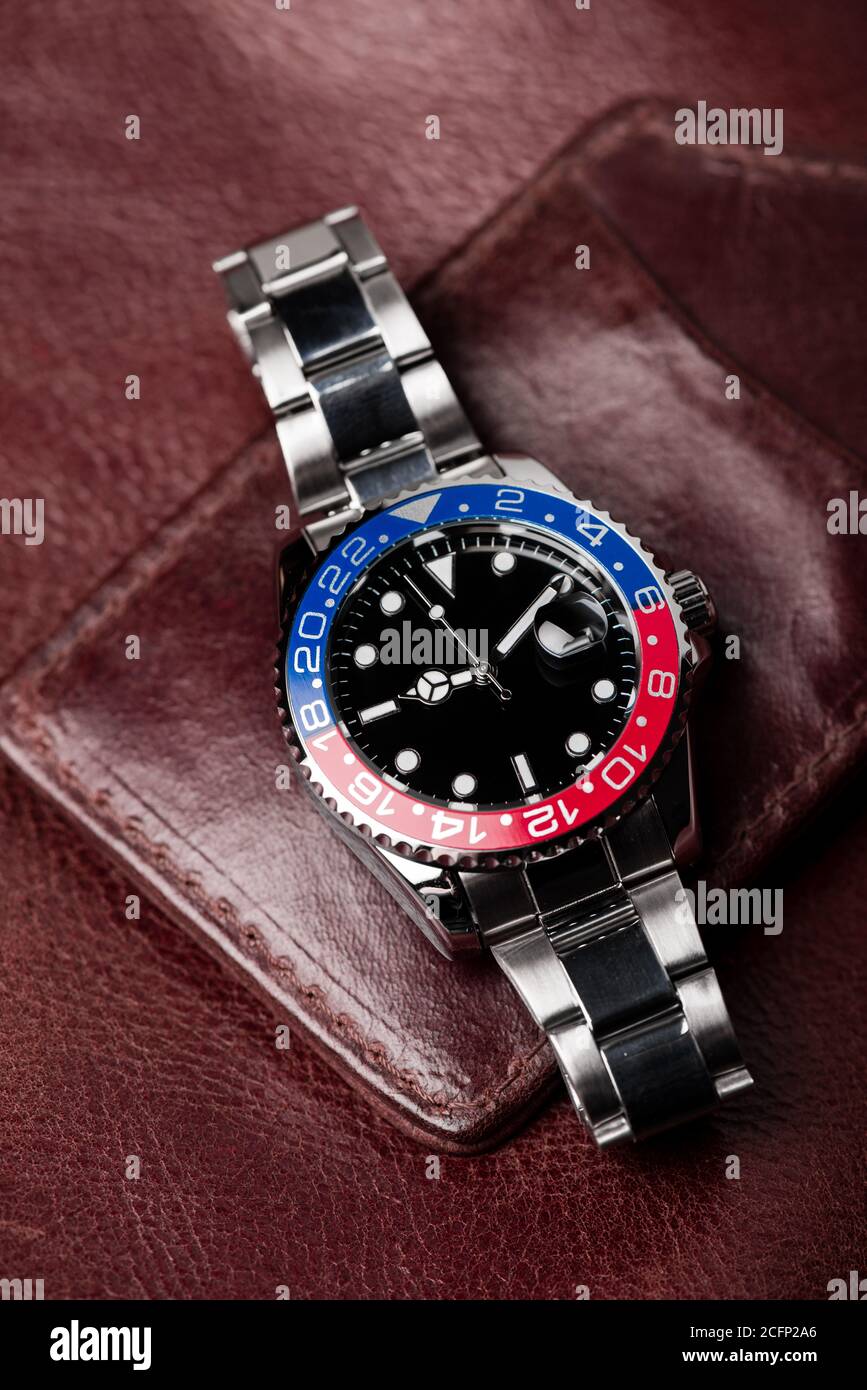 closeup luxury wristwatch for men with black dial blue-red bezel and ...