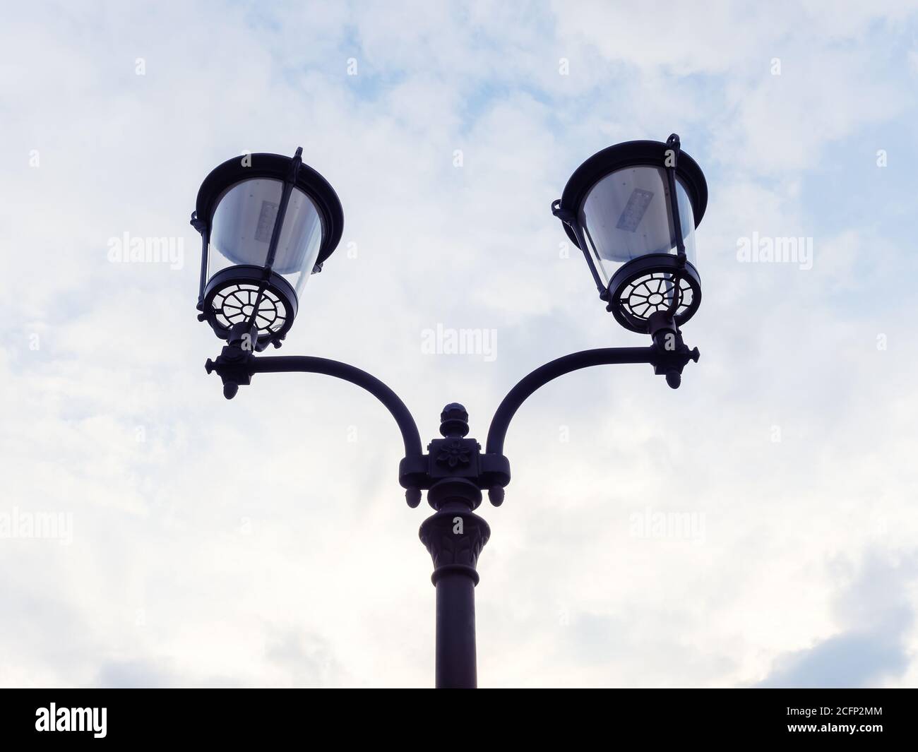 Double black lantern with transparent glass on cloudy sky background ...