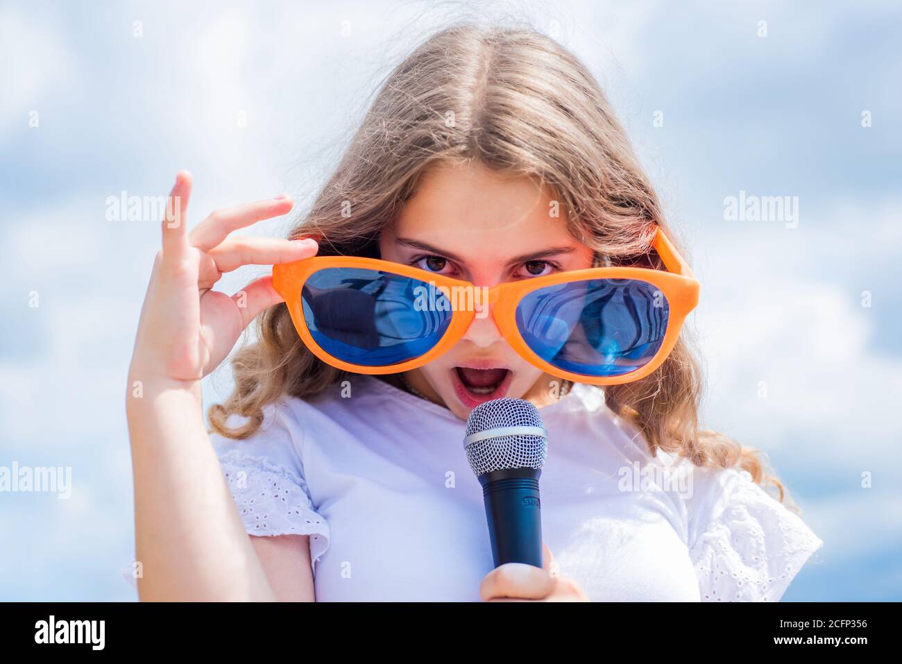 Everyone deserves good music. singer in glasses with microphone. happy ...