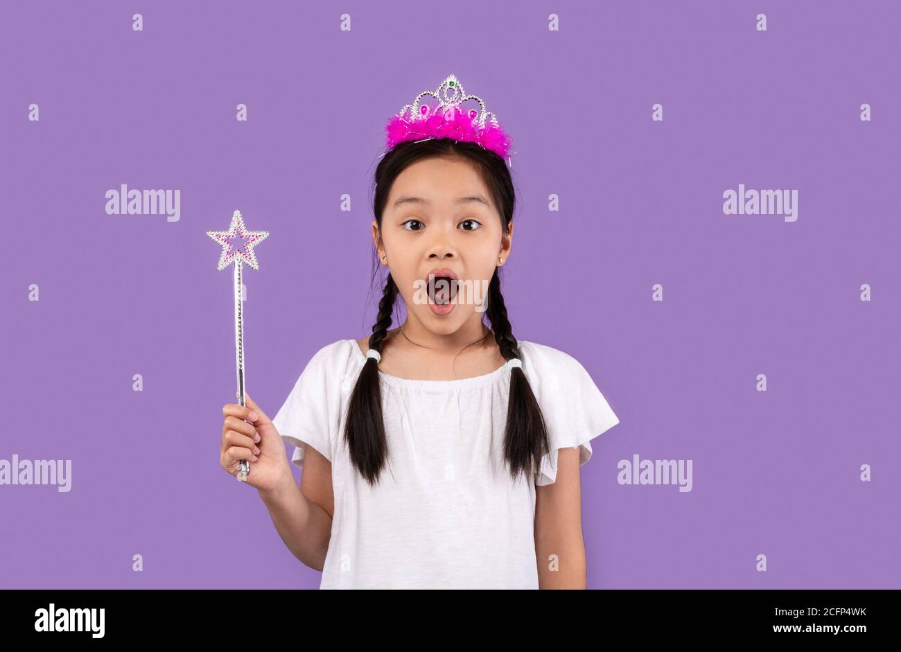 Surprised Asian Girl Holding Magic Stick Posing Over Purple Background ...