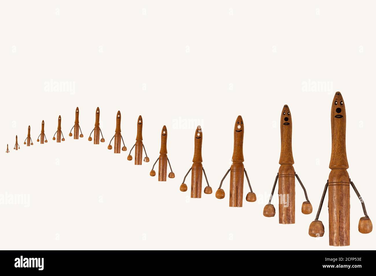 Wooden rattle depicted as a little man in various positions ...