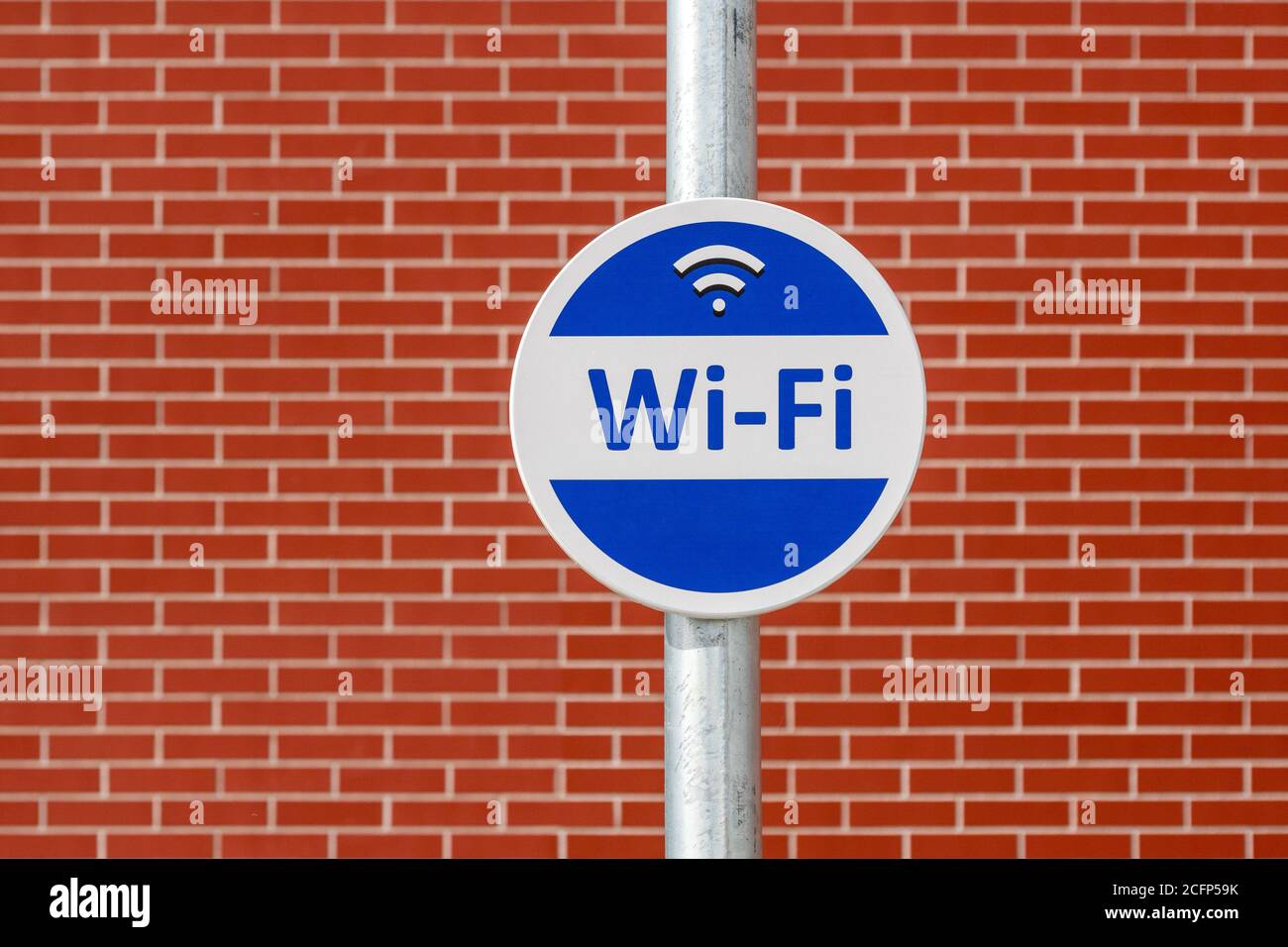 Free wi-fi zone sign in the city in front of brick wall Stock Photo - Alamy