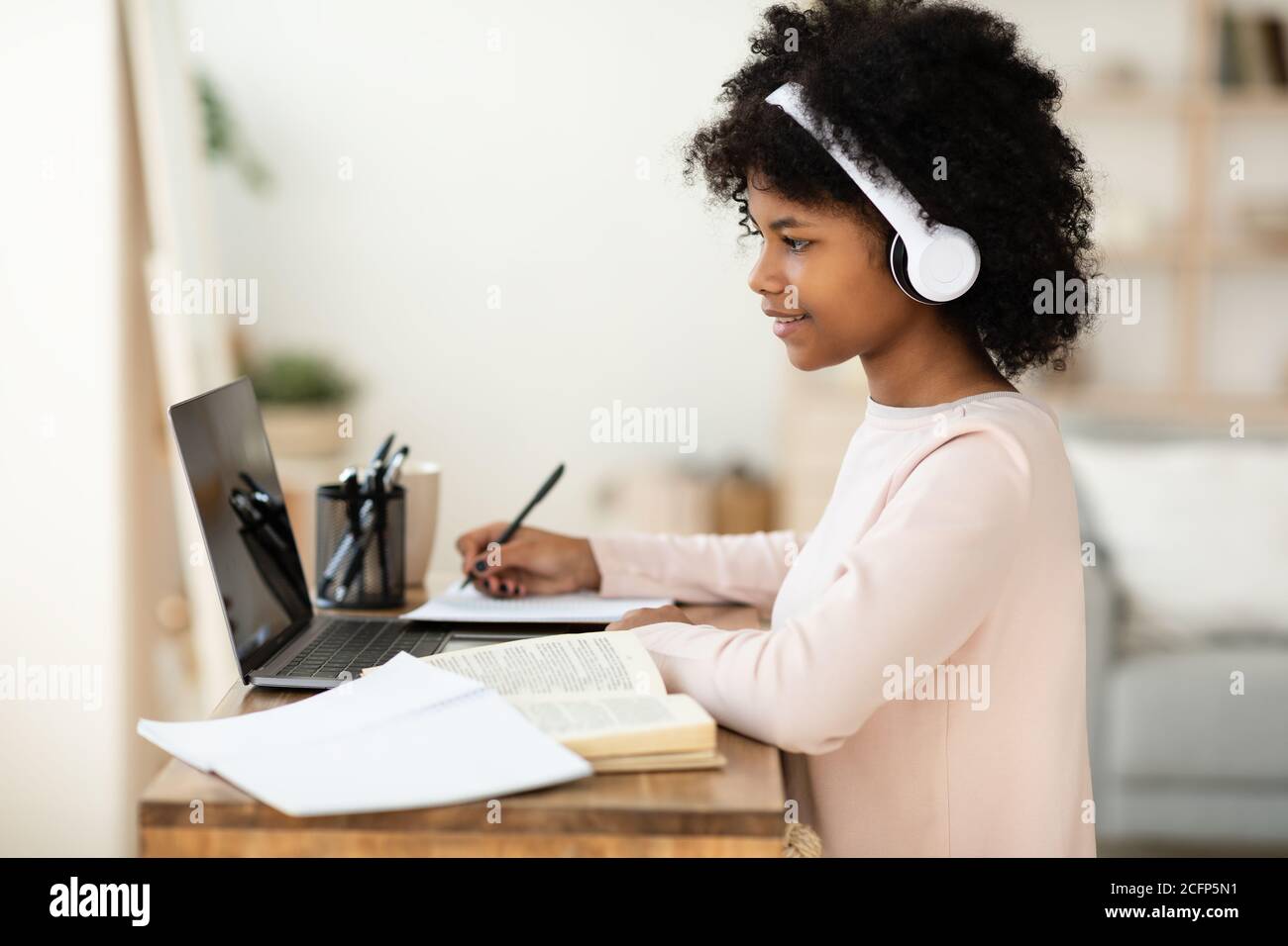Happy teen schoolgirl doing homework hi-res stock photography and ...