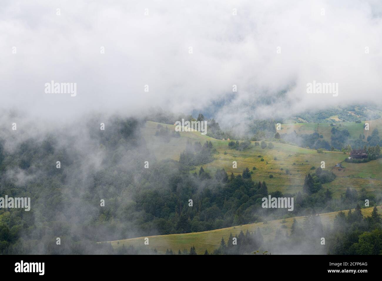 Majestic view on beautiful fog and cloud mountains in mist landscape. Summer time after rain ...