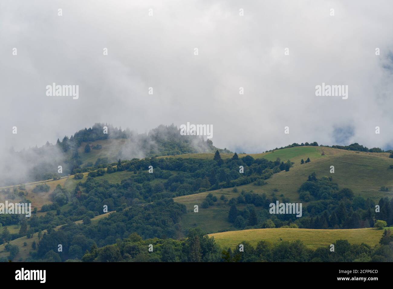 Majestic view on beautiful fog and cloud mountains in mist landscape. Summer time after rain ...
