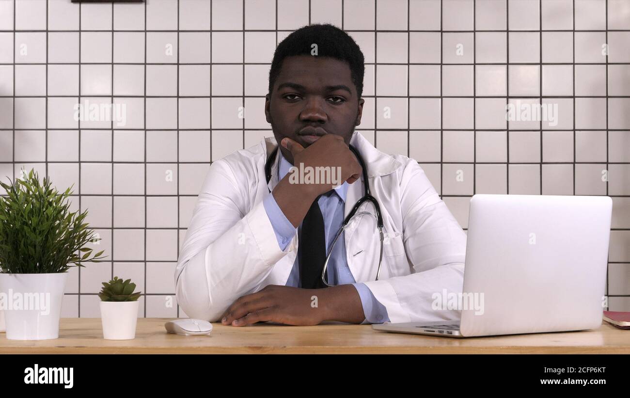 African American doctor looking serious to camera thinking Stock Photo ...