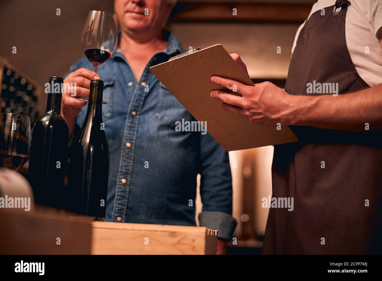 Professional sommeliers evaluating red wine and making notes Stock ...