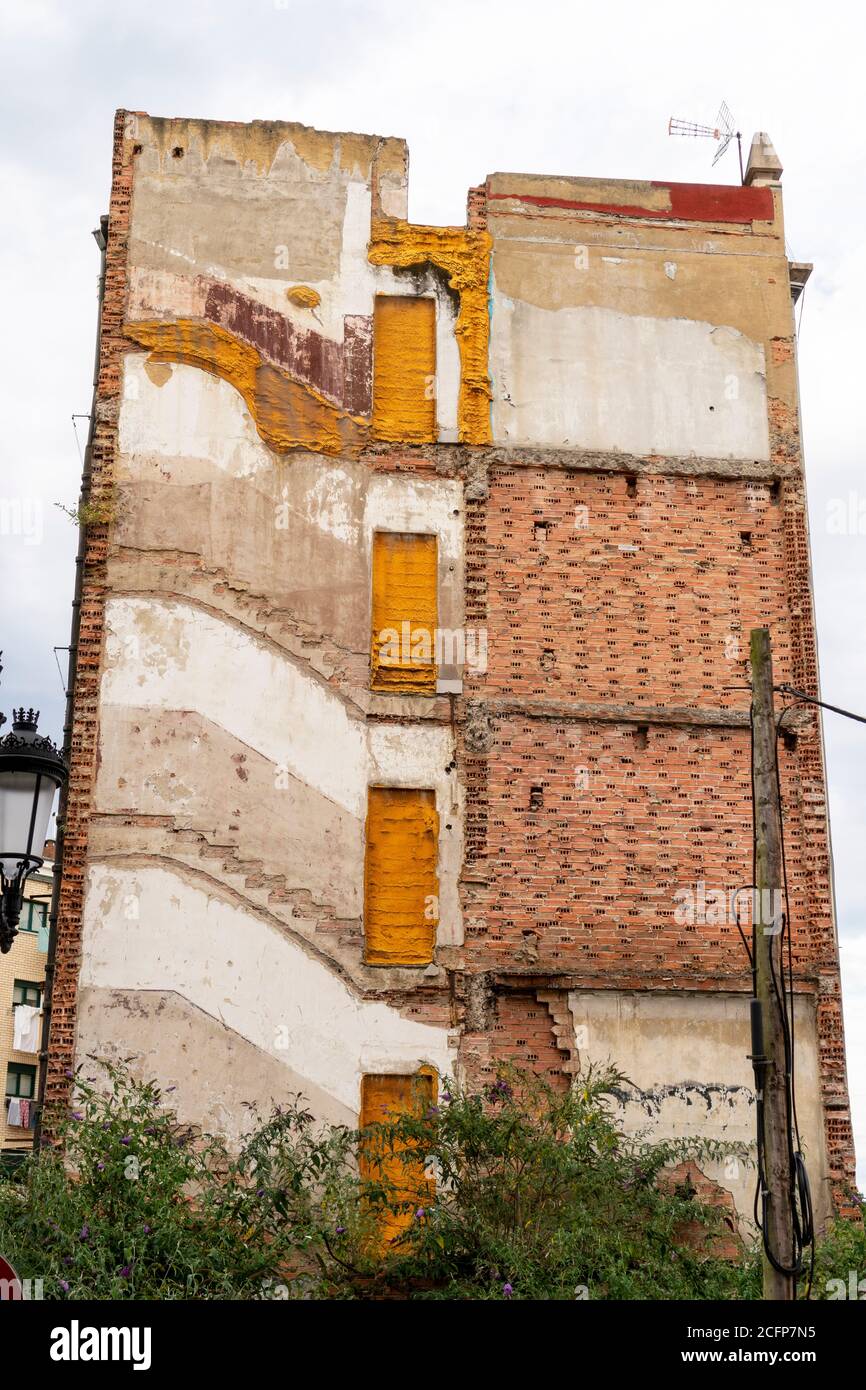 The destroyed wall of an abandoned residential building close-up ...