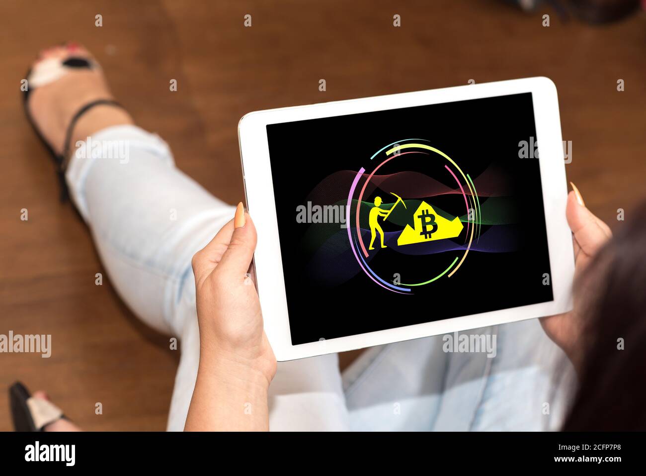 Tablet screen displaying a bitcoin mining concept Stock Photo - Alamy