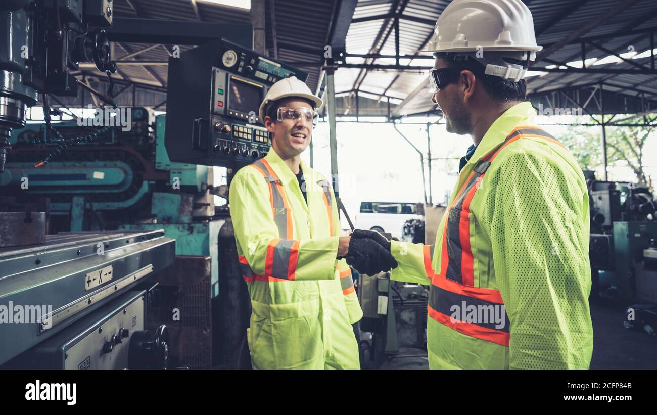 Factory workers handshake with team member in the factory Stock Photo ...