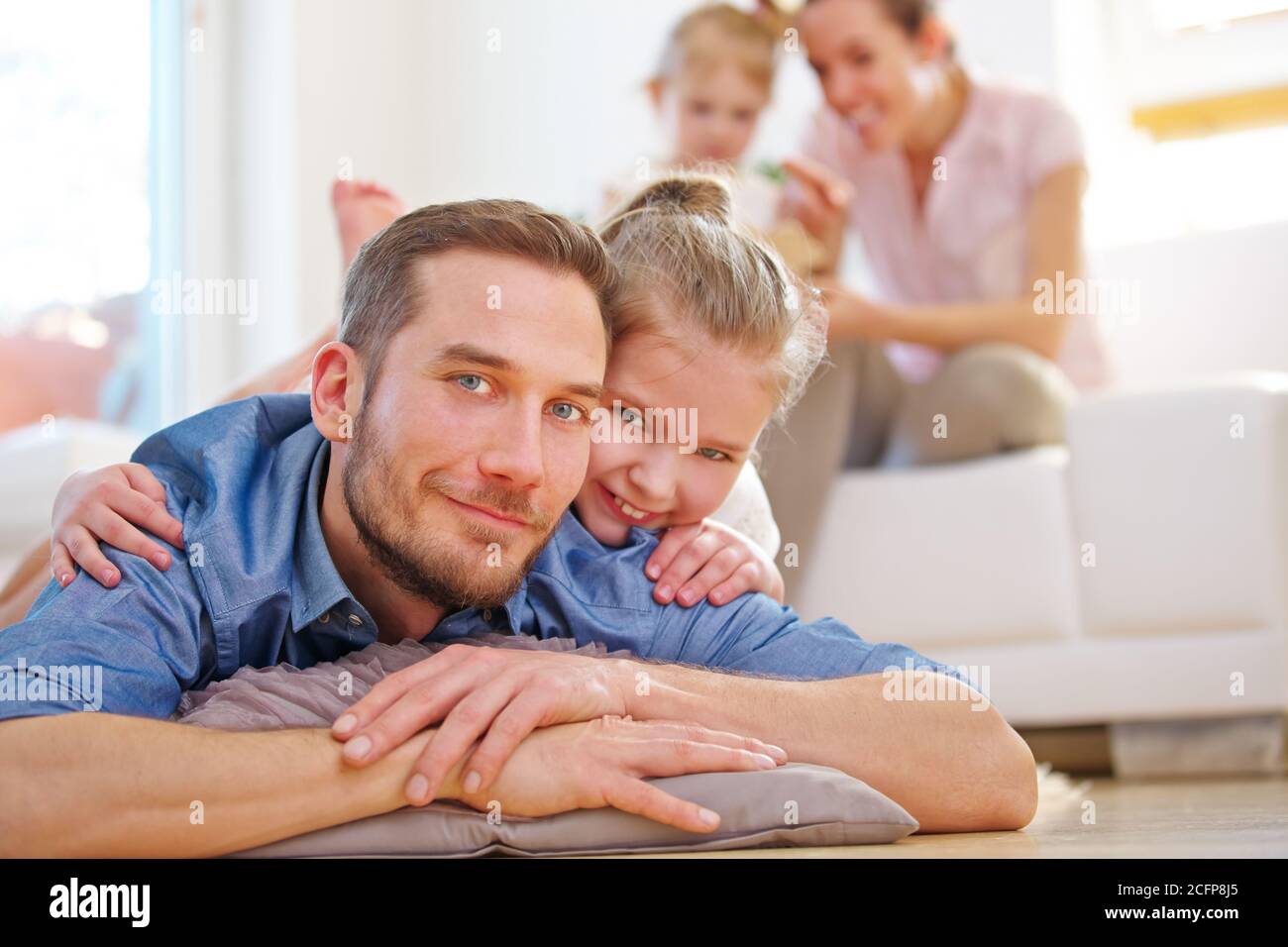 Happy family and two kids at home in the living room Stock Photo - Alamy