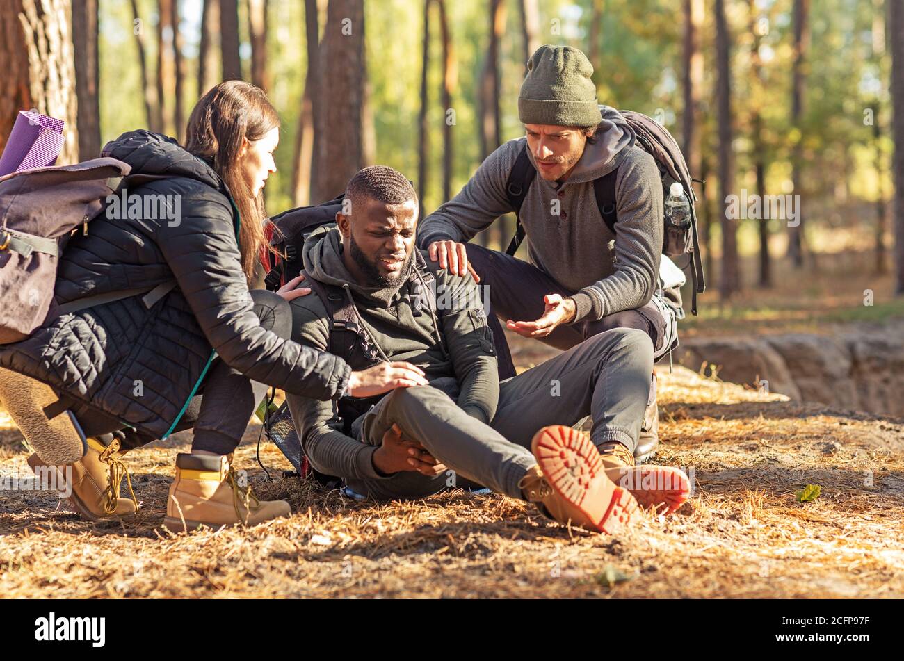 Friends helping hurt hi-res stock photography and images - Alamy