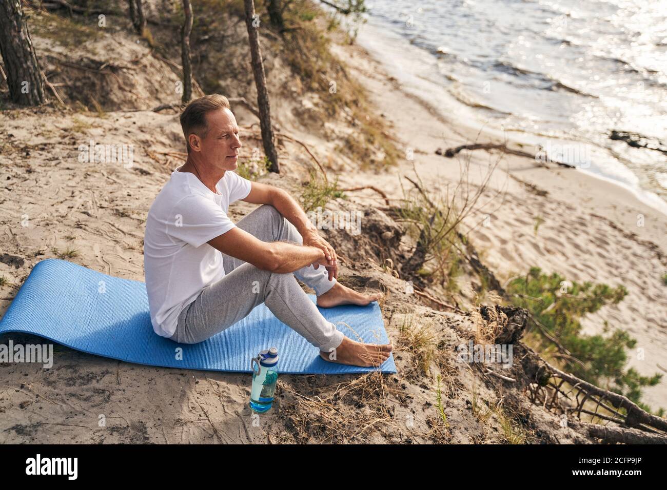 Happy man relaxing in solitude in nature Stock Photo - Alamy