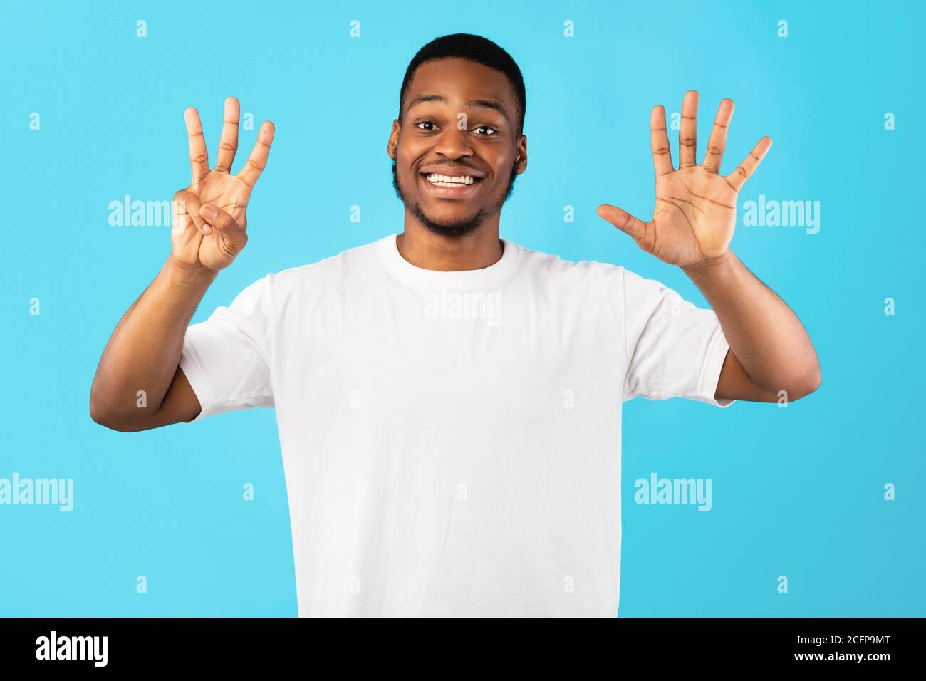 Black Man Showing Number Eight Counting On Fingers, Blue Background ...