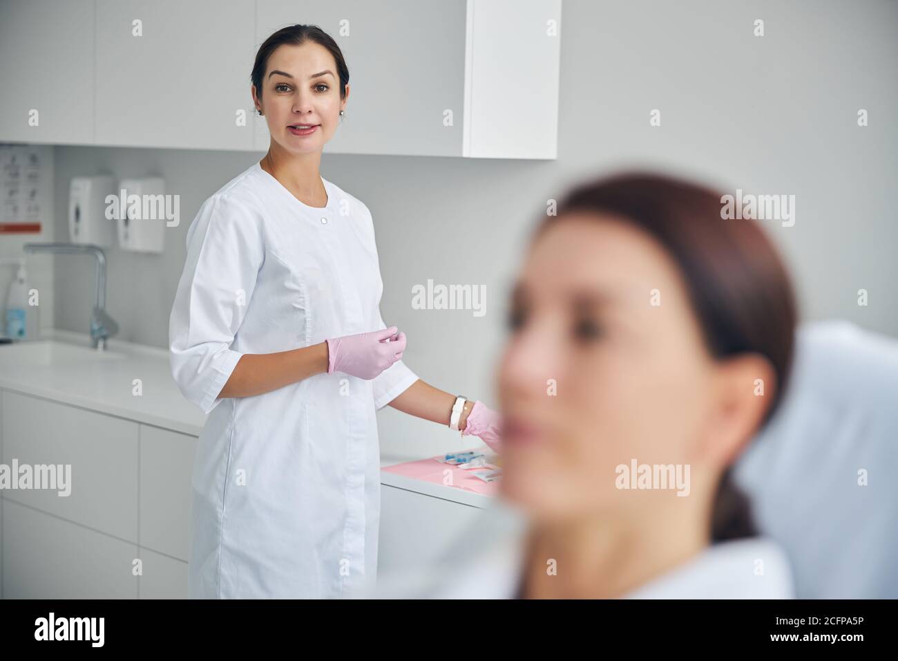 Certified female cosmetician posing for the camera Stock Photo - Alamy