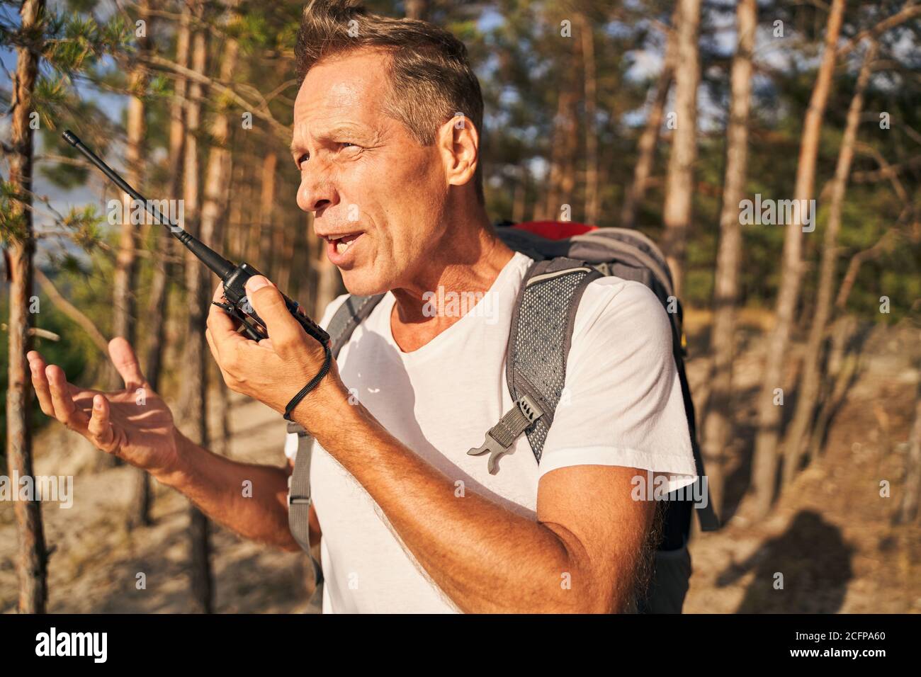 Man using walkie talkie while hiking in wood Stock Photo - Alamy