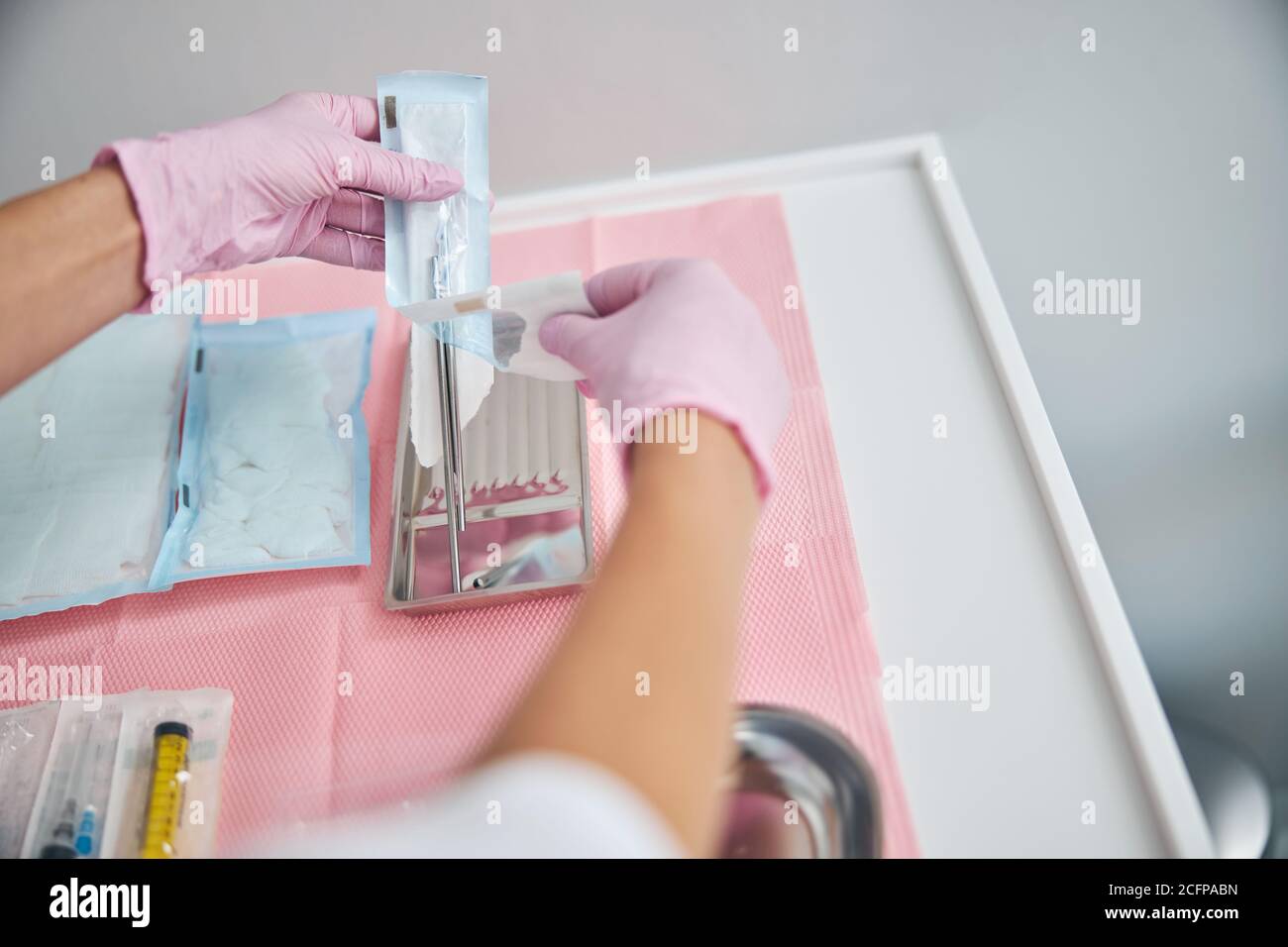 Woman doctor removing sterile surgical tools from the package Stock ...