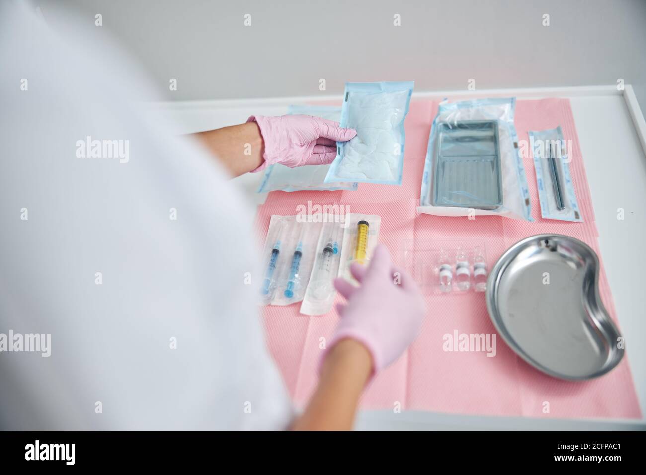 Doctor arranging instruments before a medical procedure Stock Photo - Alamy