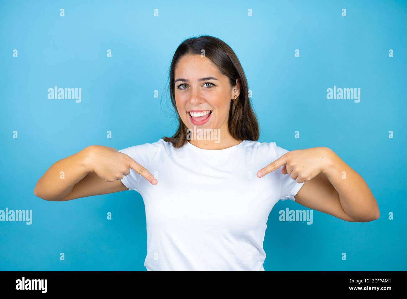 Young beautiful woman over isolated blue background looking confident ...