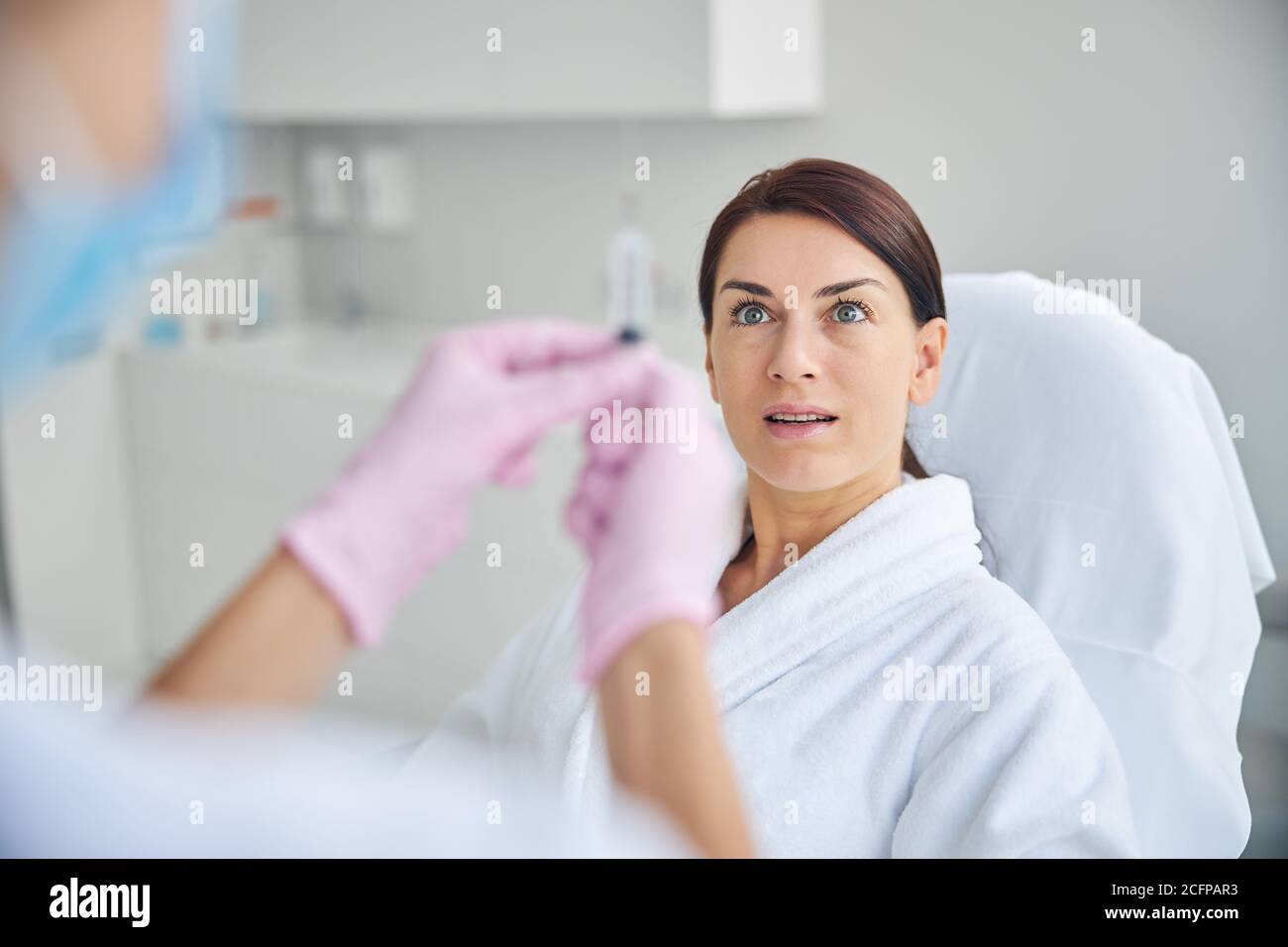Female patient feeling scared before an injection Stock Photo - Alamy