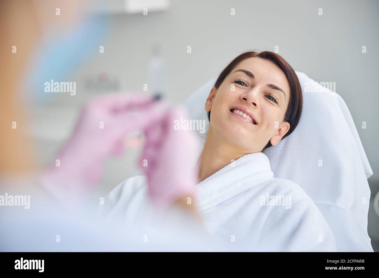 Patient in a bathrobe smiling before a medical procedure Stock Photo ...