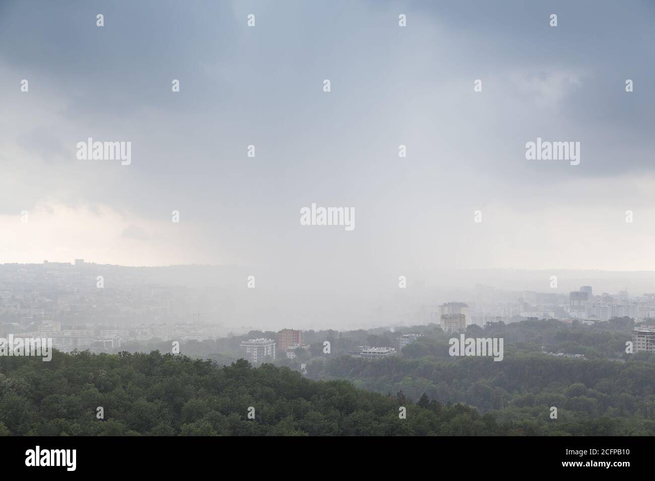 Dark cloud pouring rain over the city Stock Photo - Alamy