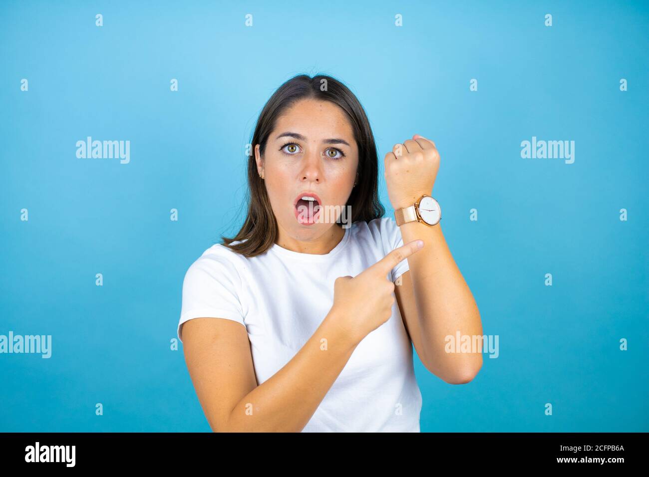 Young beautiful woman over isolated blue background surprised and ...