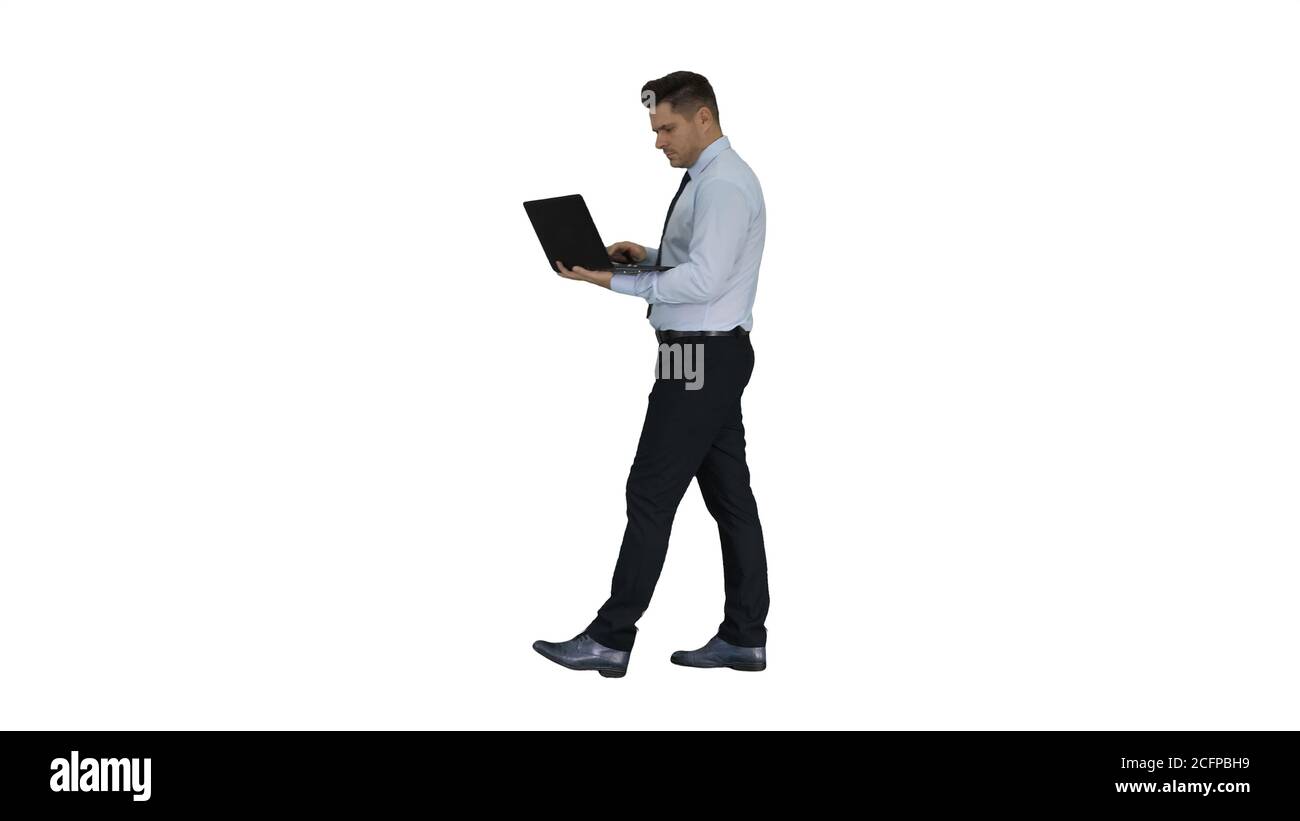 Formal man walking and using laptop on white background Stock Photo - Alamy