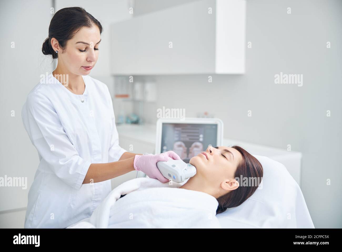 Relaxed lady getting a skin tightening treatment Stock Photo - Alamy