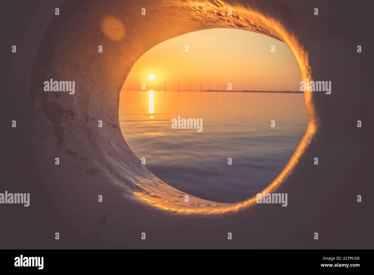 Sunset glowing through Close up of anchor hawse hole on an old boat ...