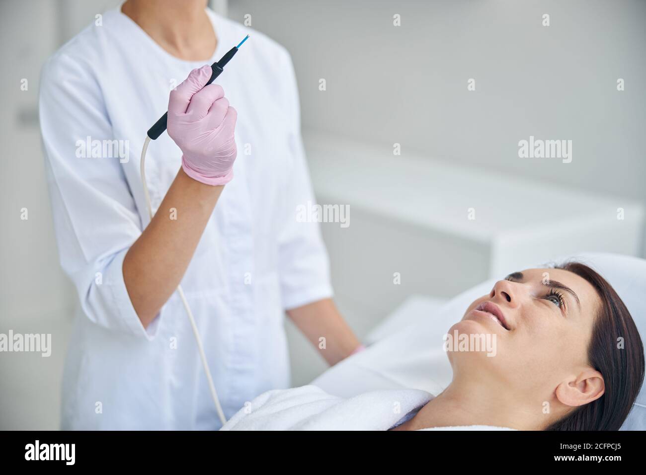 Pleased woman being treated by a professional dermatologist Stock Photo ...