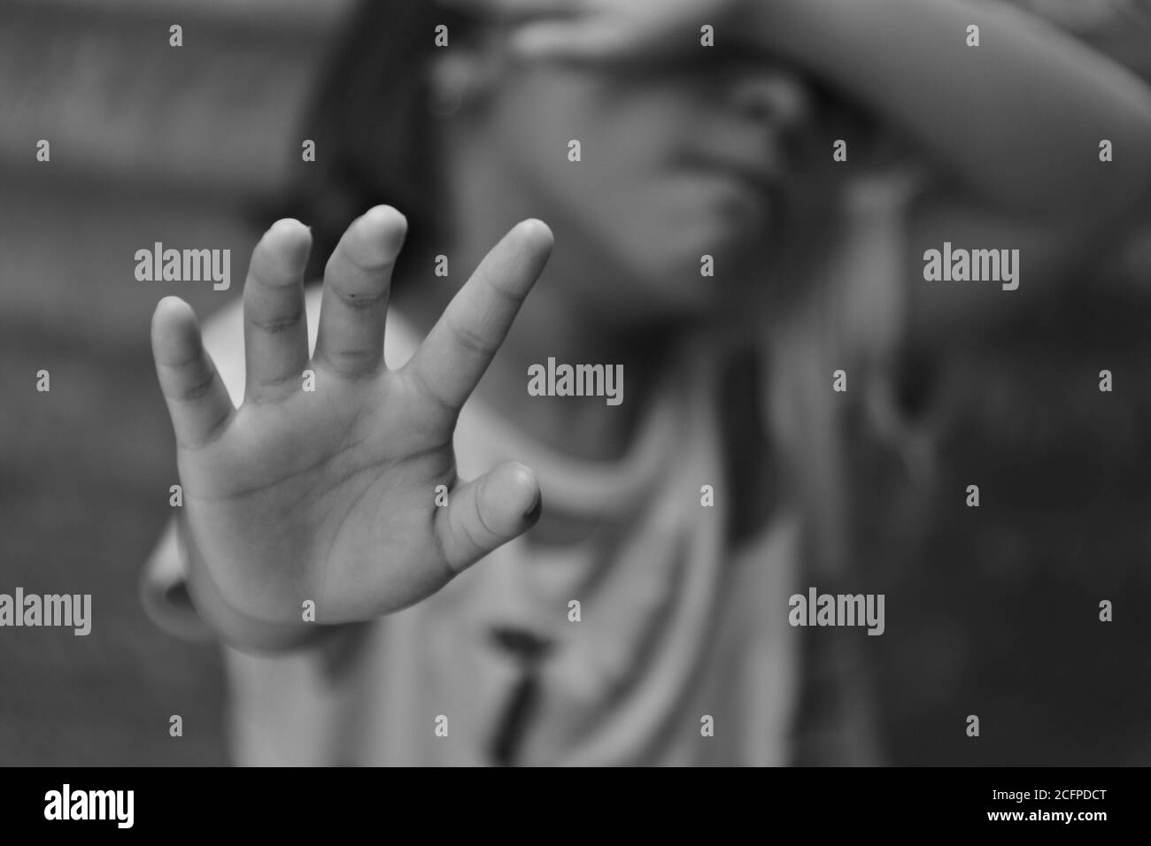 Grayscale shot of a child stopping with his hand Stock Photo - Alamy