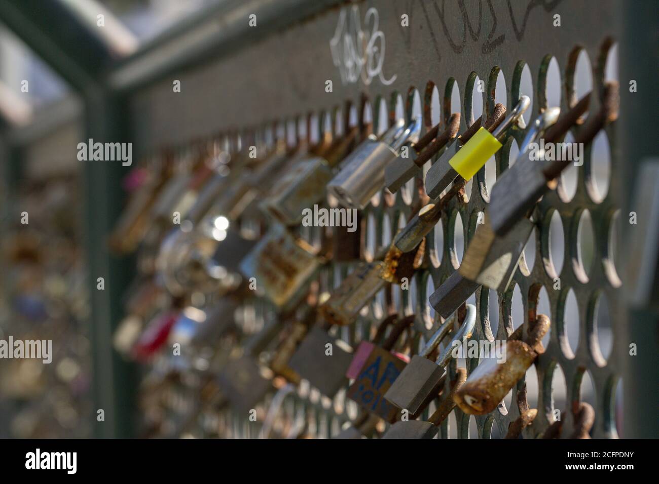 Closeup of different locks attached to a metal grid - symbol of eternal ...