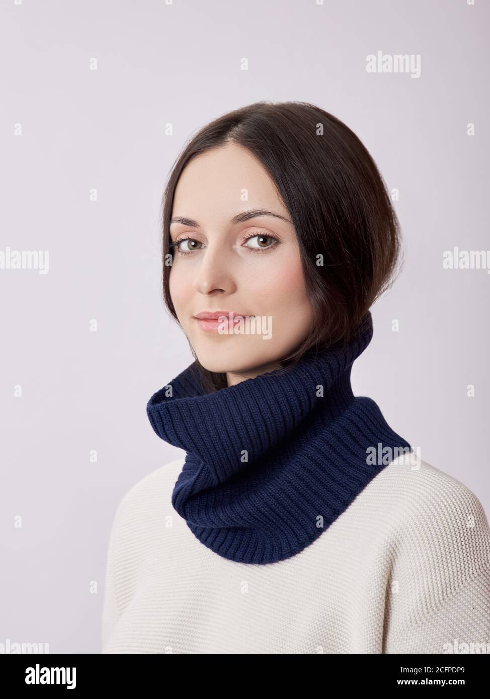 Beautiful woman in a Snood scarf on a white background. Autumn warm ...