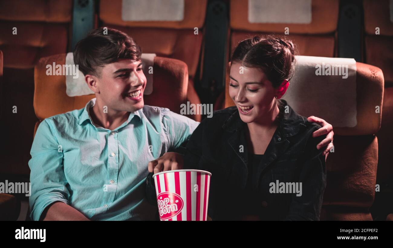 Men and women are eating and tossing popcorn Stock Photo - Alamy