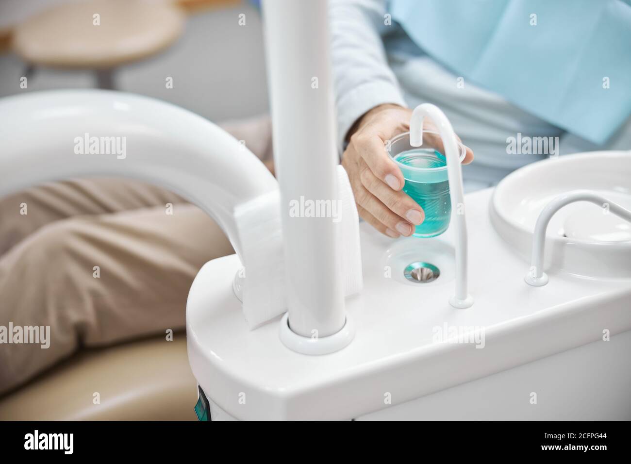 Patient of a dental clinic getting some water to rinse his mouth Stock ...