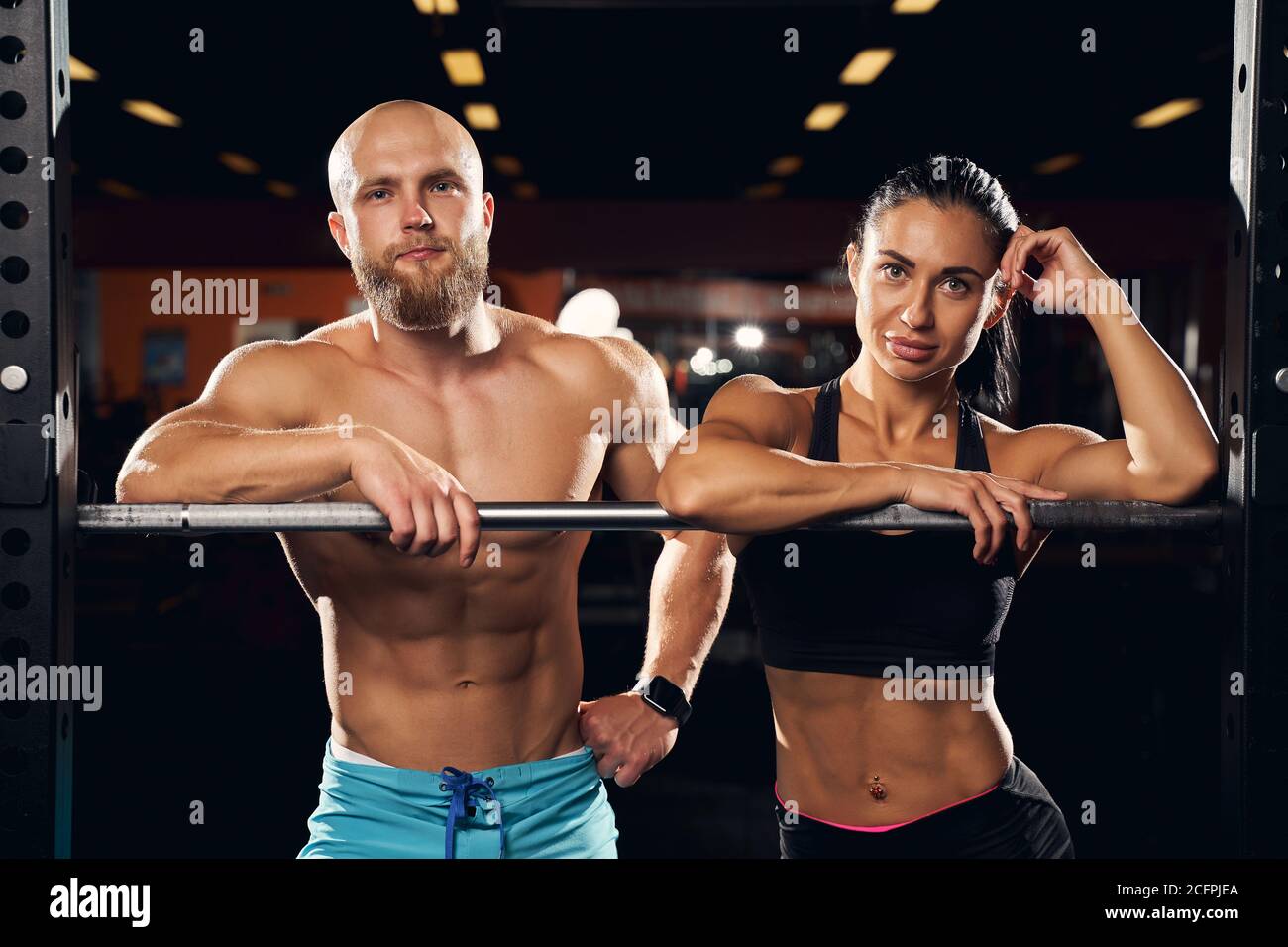 Well-built man and his strong girlfriend posing at the gym Stock Photo ...