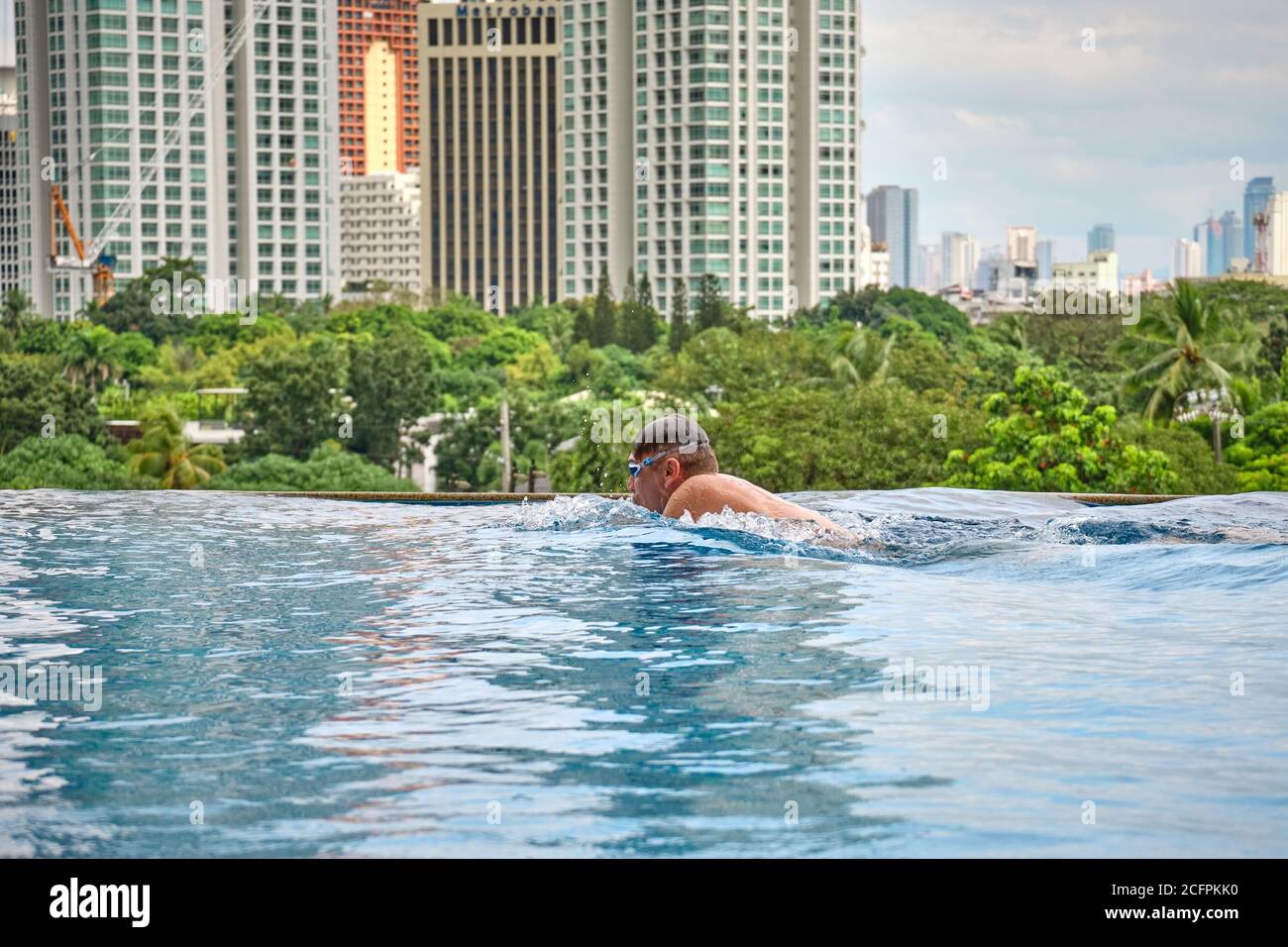 Manila, Philippines - Feb 02, 2020. A man swims a breaststroke in a ...