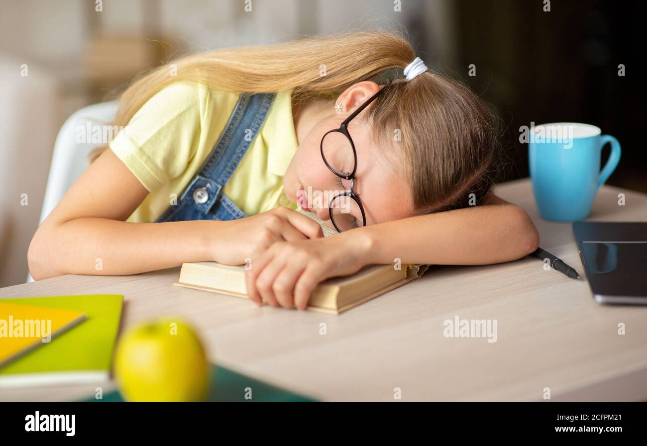 Tired teenager at table hi-res stock photography and images - Alamy