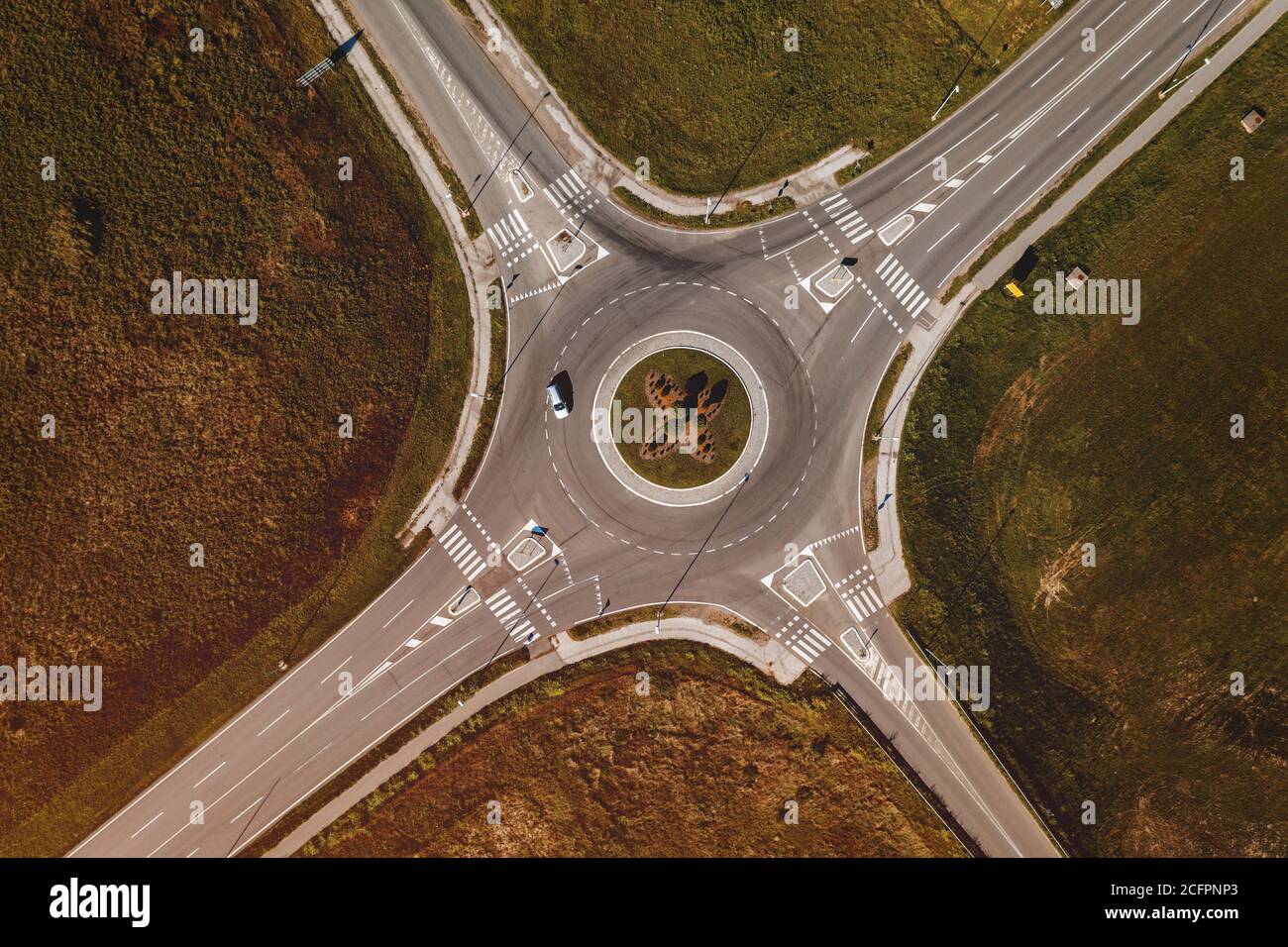 Cars on road circular intersection roundabout, top view drone pov Stock ...