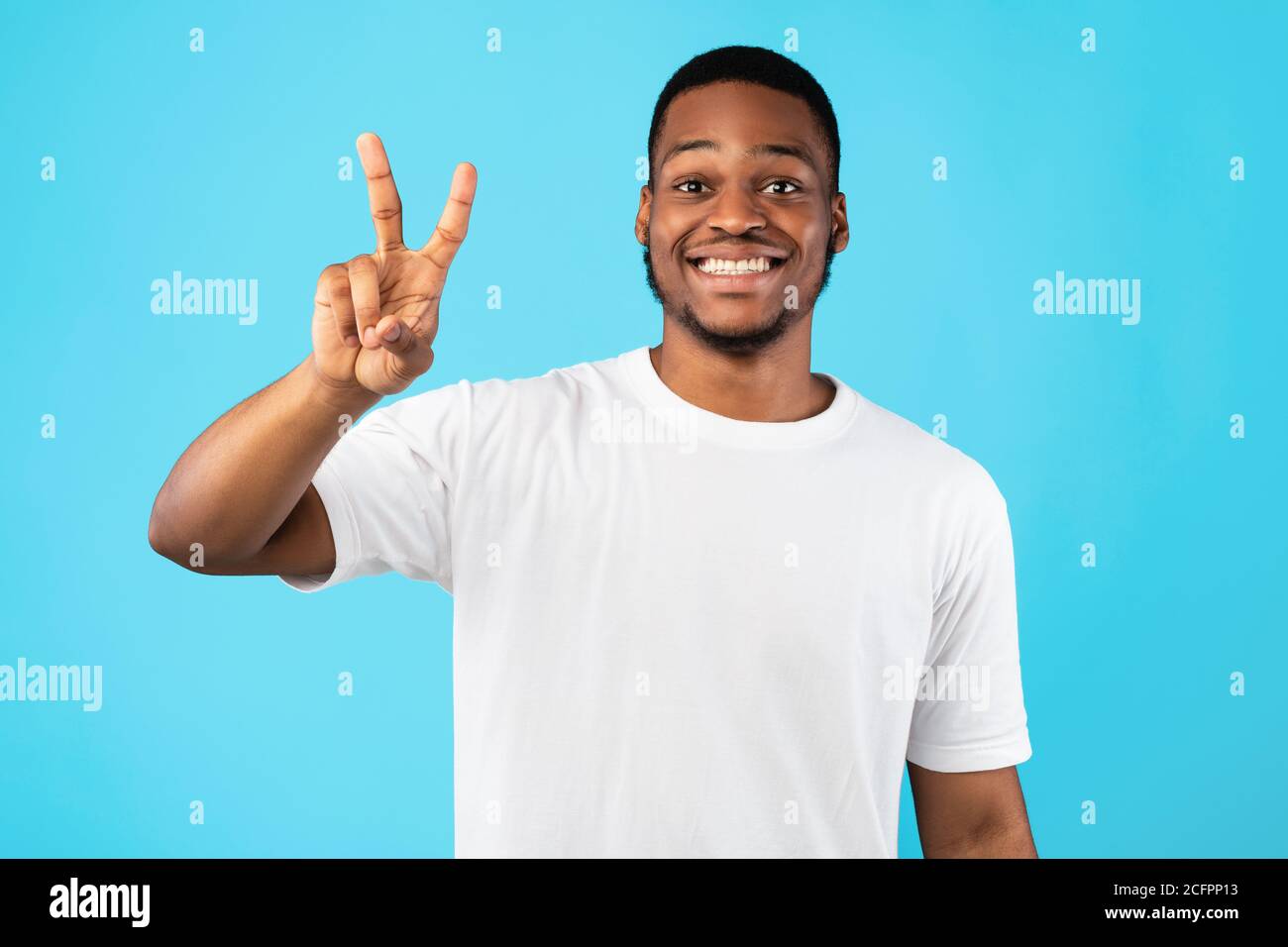 African Man Showing Number Two Posing On Blue Studio Background Stock ...