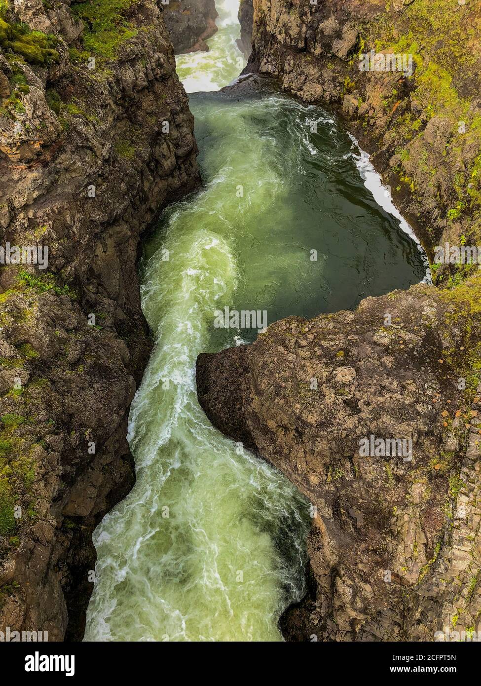 Beautiful green powerful river flowing in Iceland between cliff rocks ...